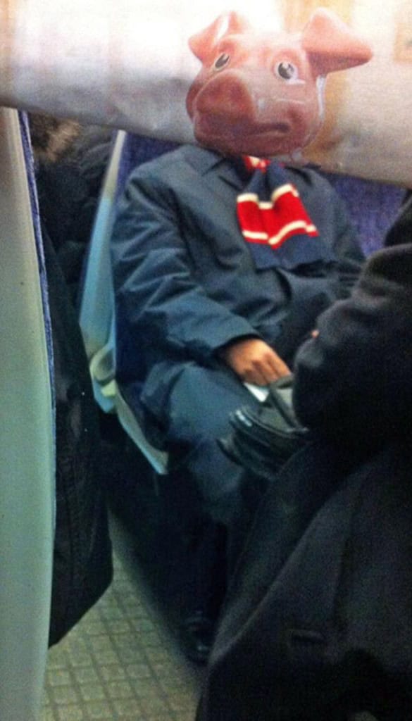 Bored Commuter Places Newspaper Heads on People's Bodies